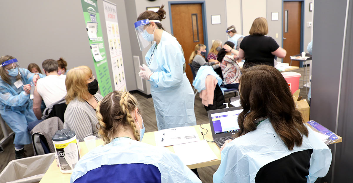 School nurses administer group vaccinations to teachers